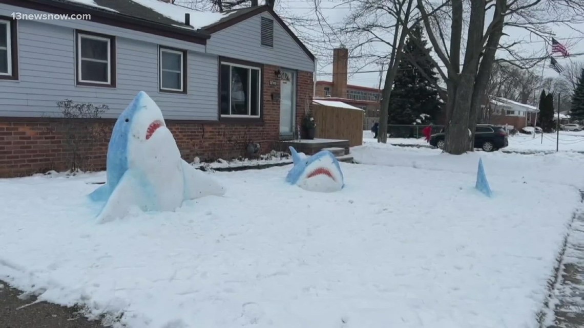 Michigan teacher sculpts 'snow sharks' in front yard | 13newsnow.com